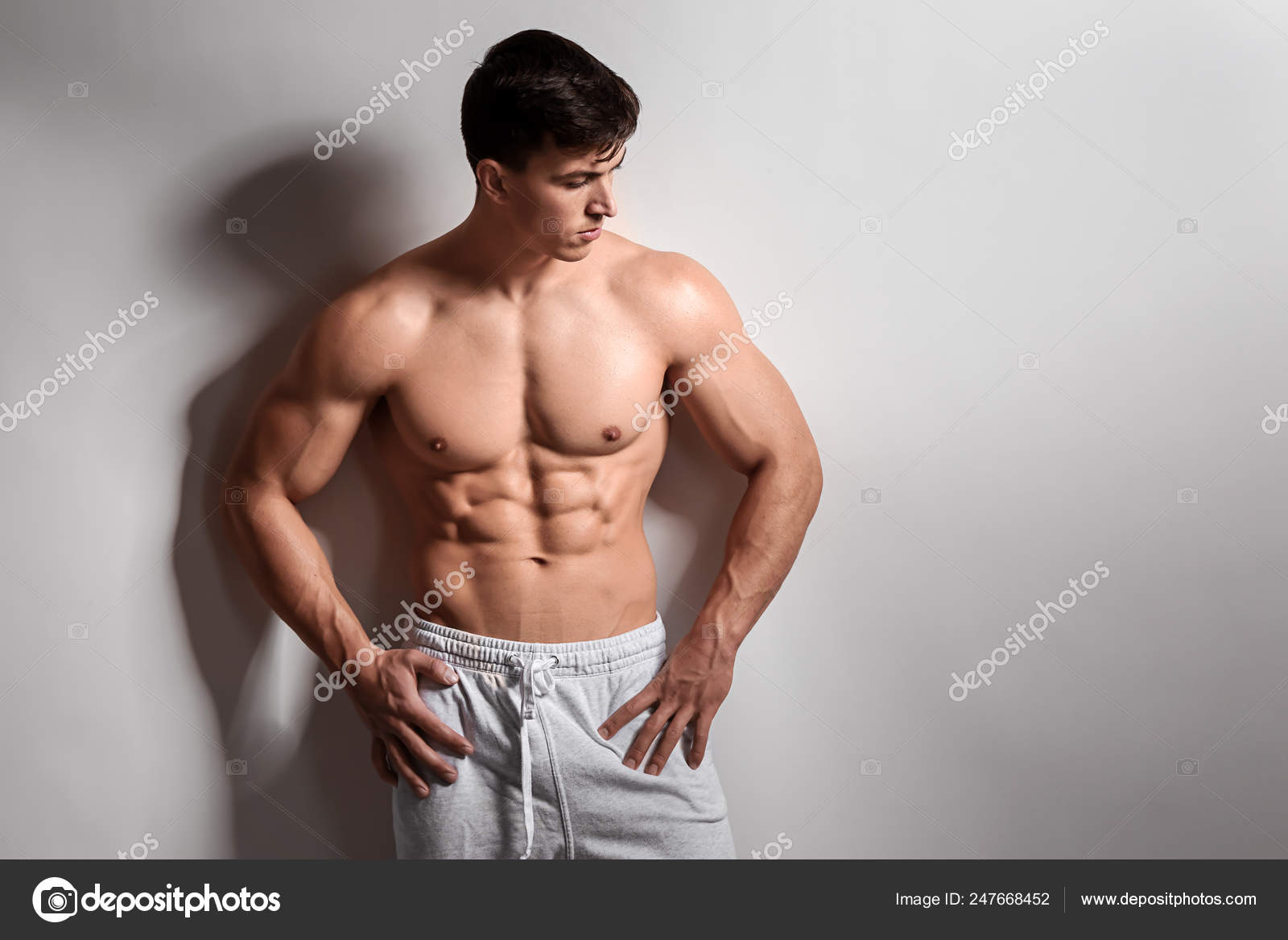Muscular bodybuilder on light background Stock Photo by ©serezniy 247668452