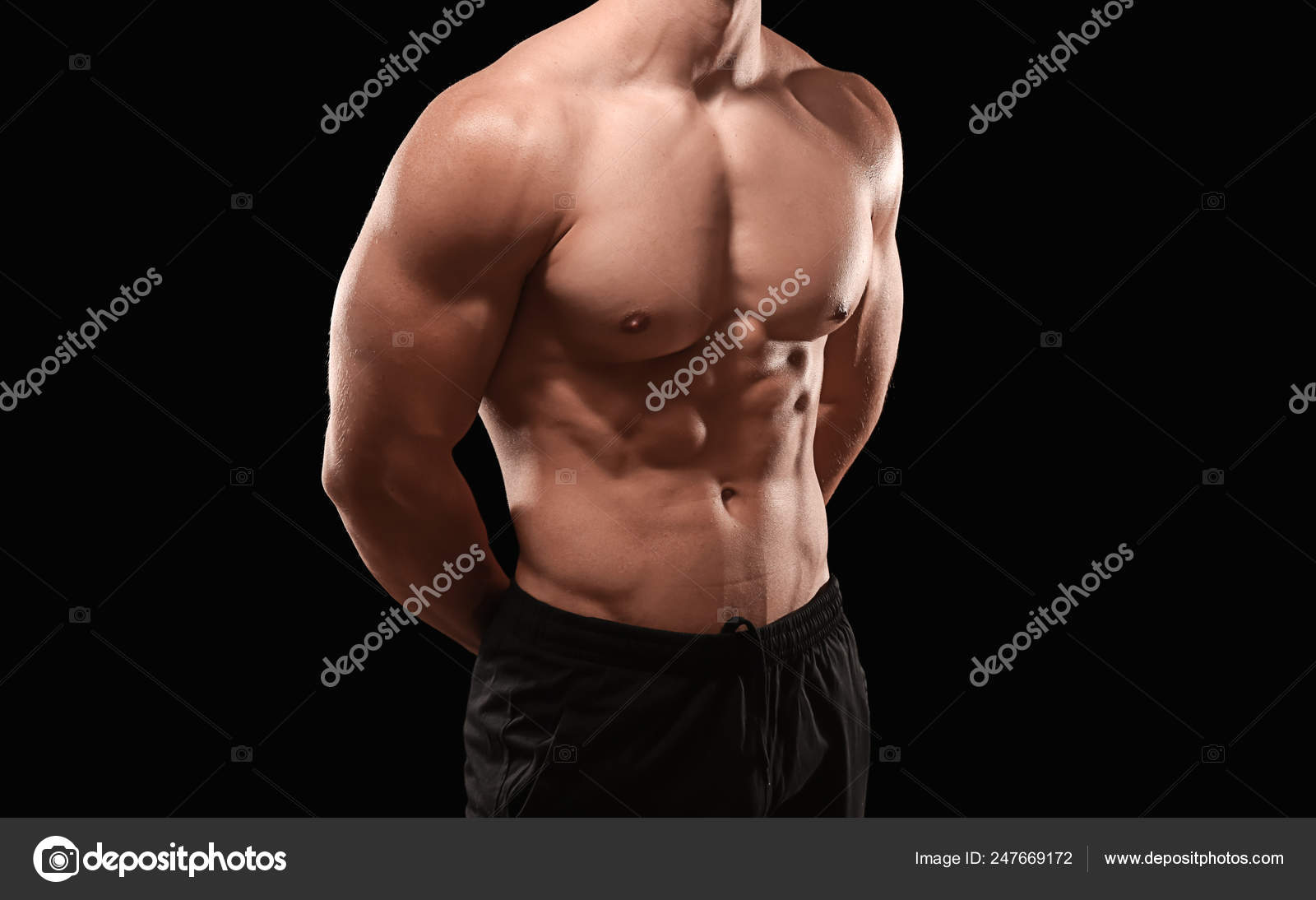 Muscular bodybuilder on dark background Stock Photo by ©serezniy 247669172