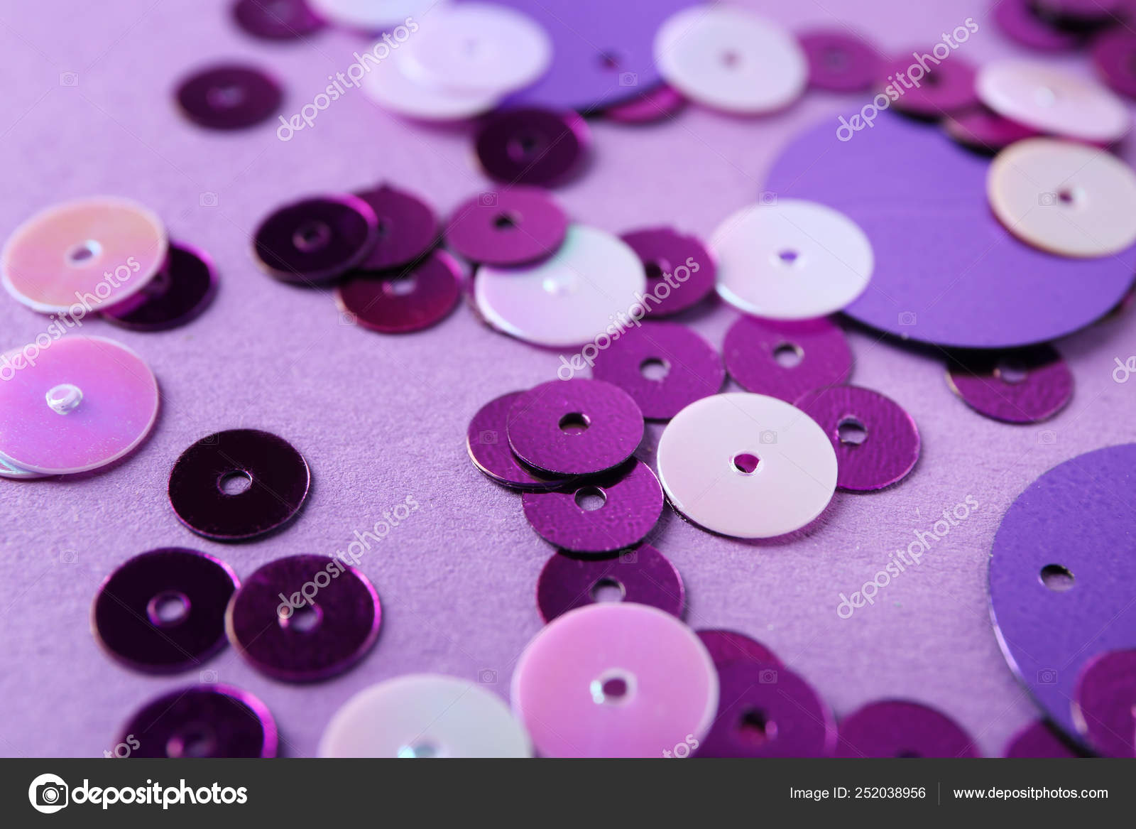 Different sequins on color background Stock Photo by ©serezniy 252038956