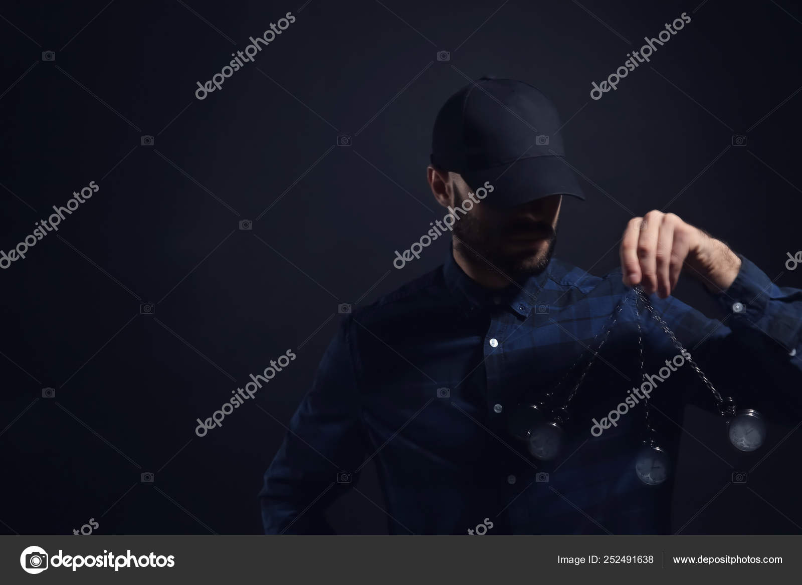 Male hypnotist with swinging pendulum on dark background — Stock Photo ...