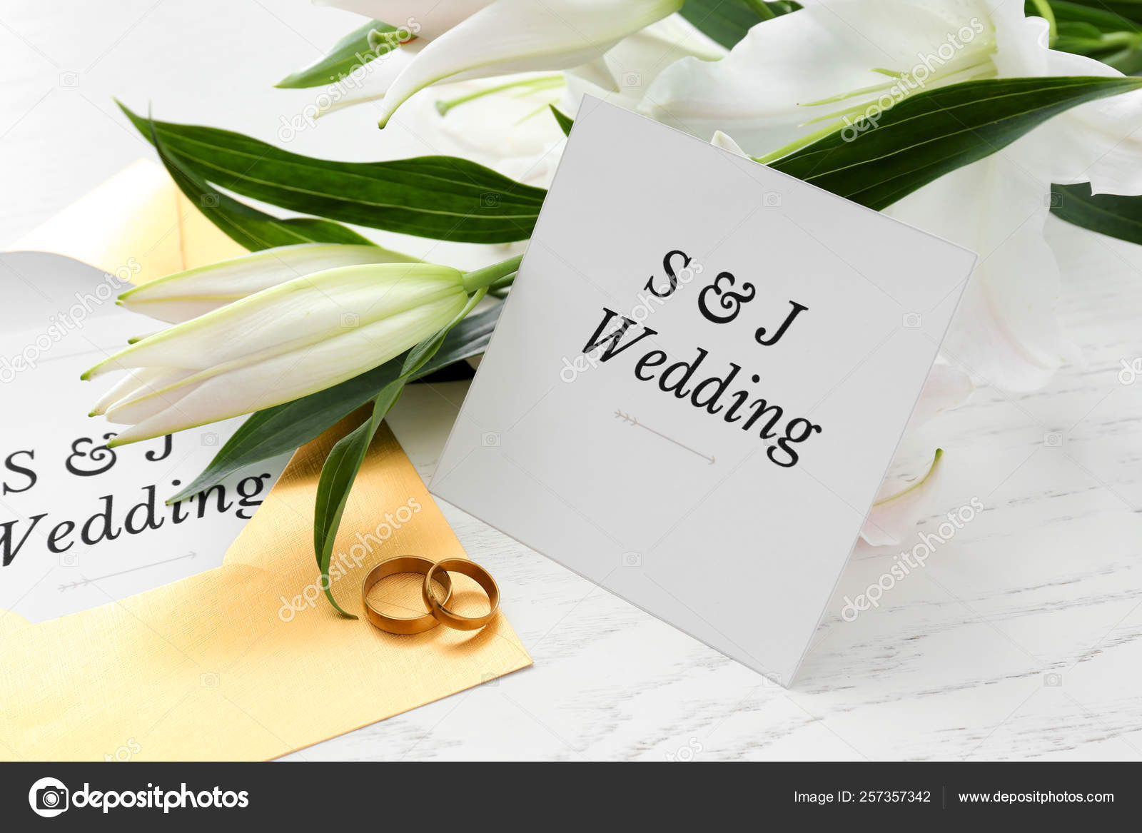 Wedding invitations, rings and flowers on table — Stock Photo ...