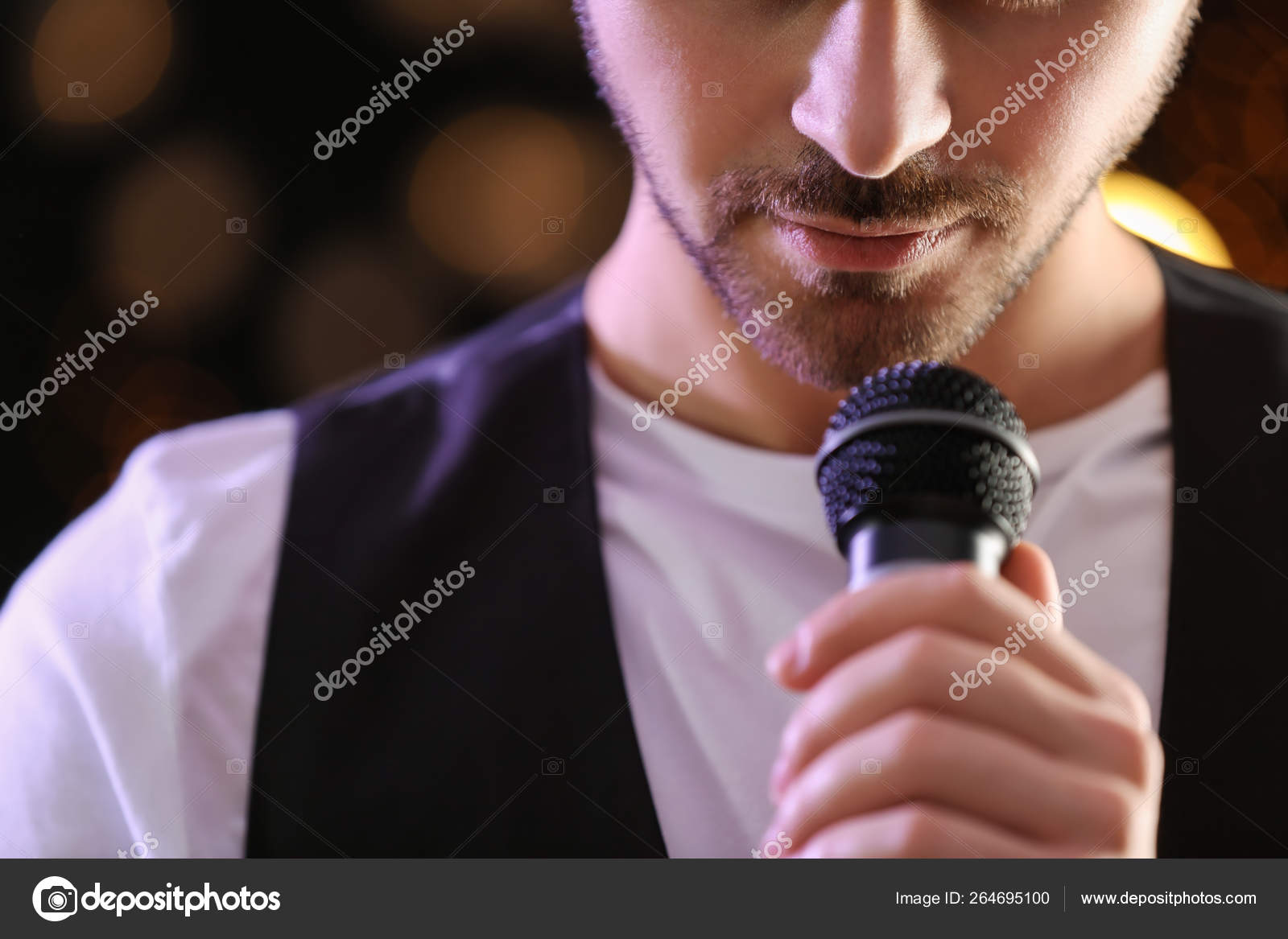 Handsome male singer with microphone on stage, closeup Stock Photo by ...