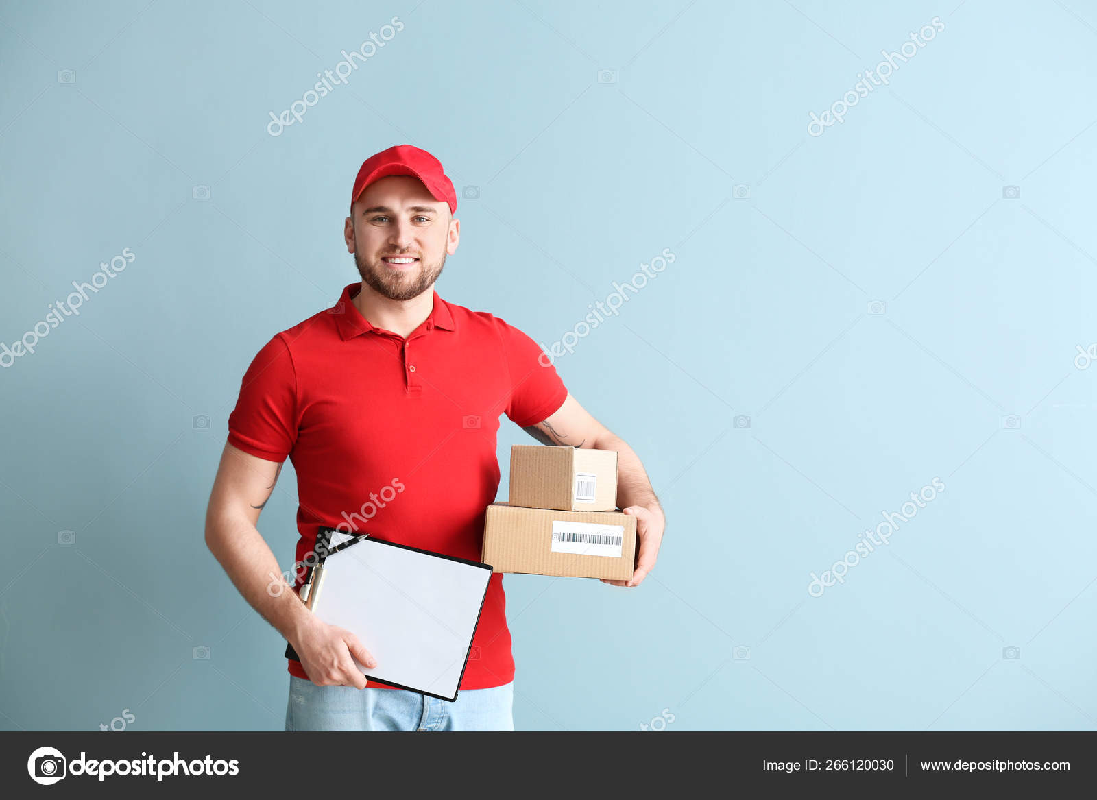 Handsome delivery man with boxes and clipboard on color background ...