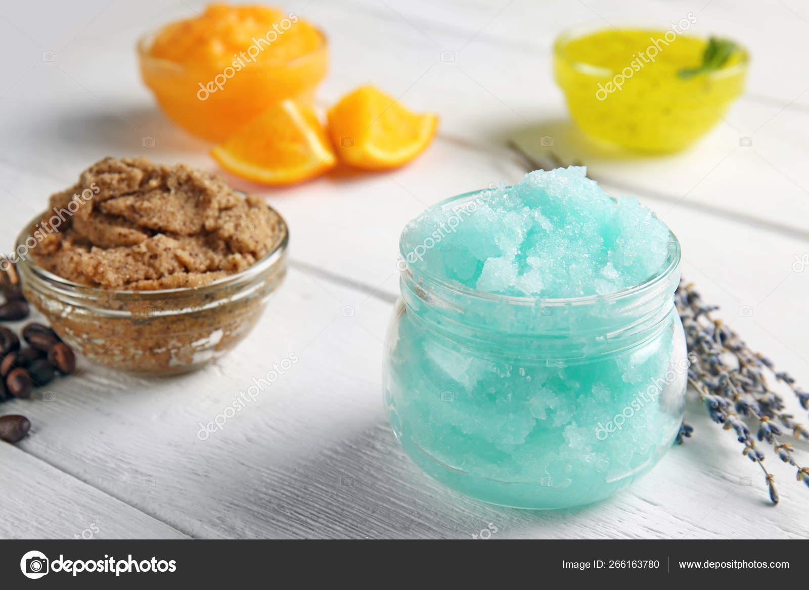 Different body scrubs on white wooden background Stock Photo by ...
