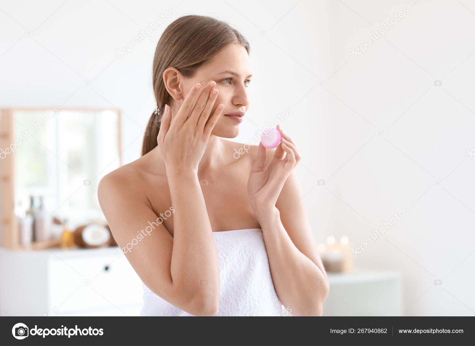 Beautiful young woman applying cream at home Stock Photo by ©serezniy ...