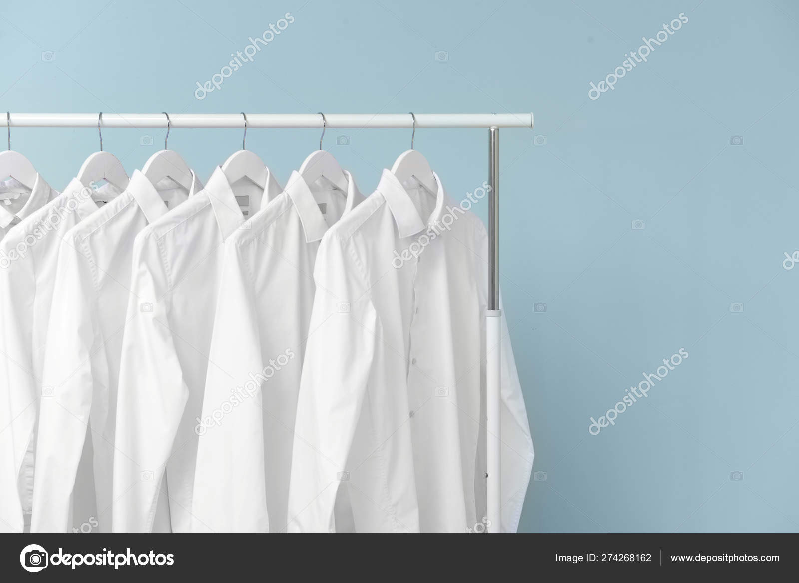 Rack with clothes after dry-cleaning on light background — Stock Photo ...