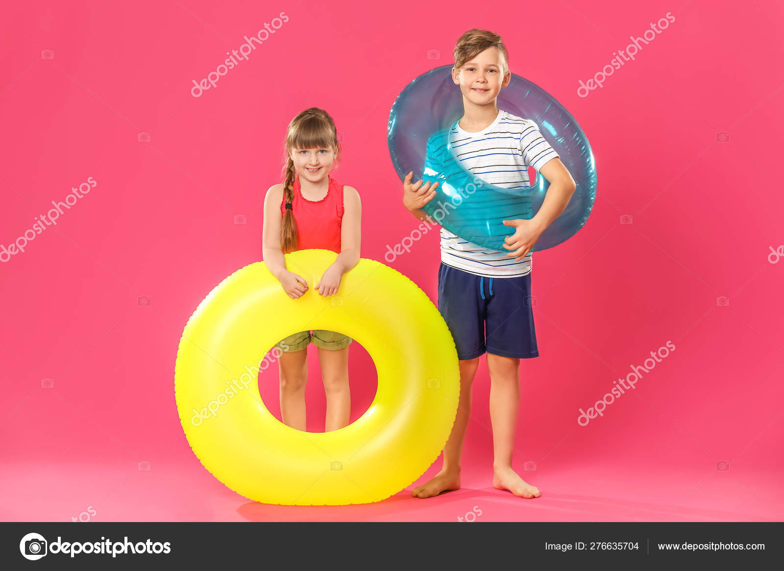 Cute little children with inflatable rings on color background Stock ...