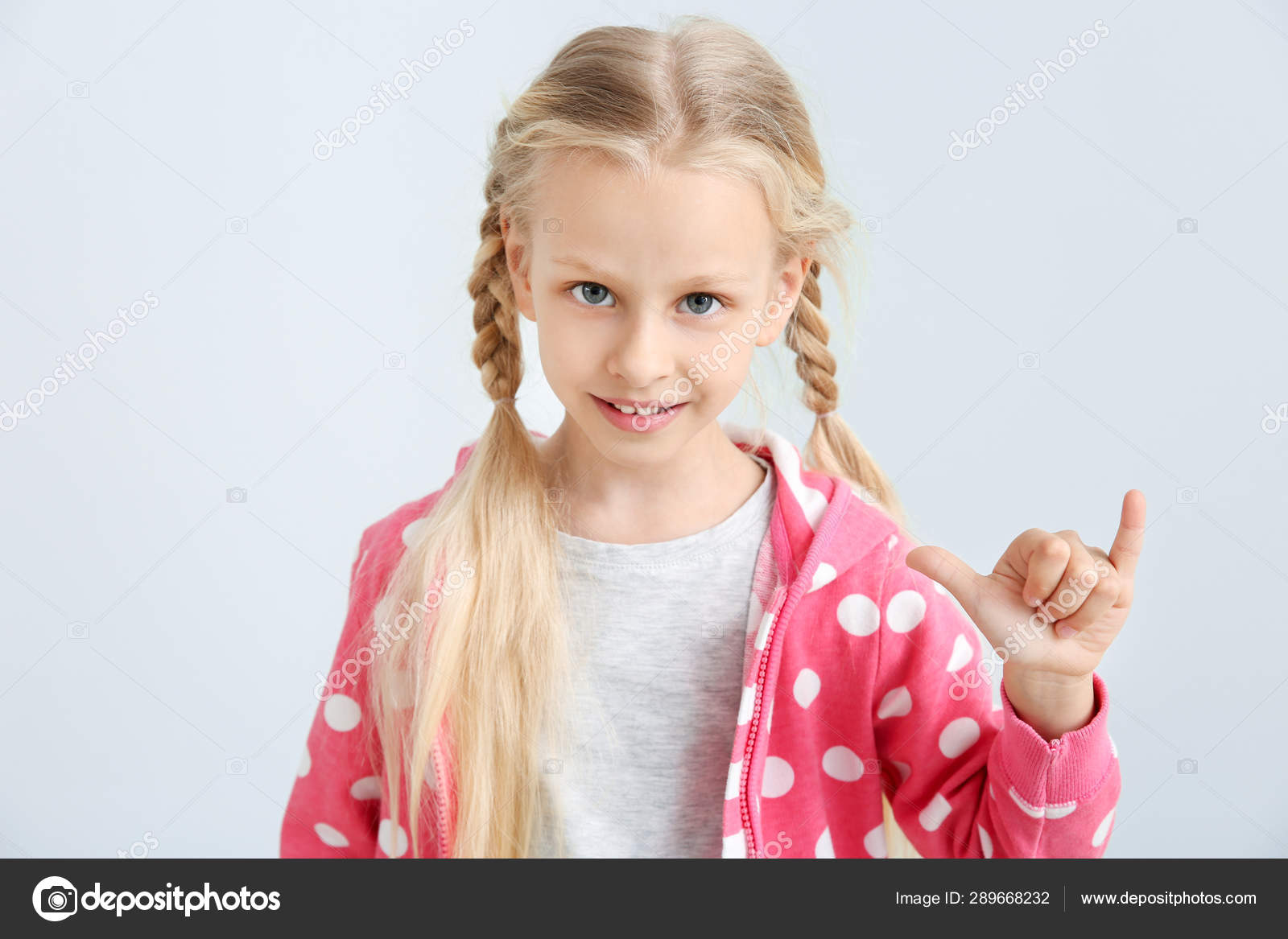 Little deaf mute girl using sign language on light background Stock ...