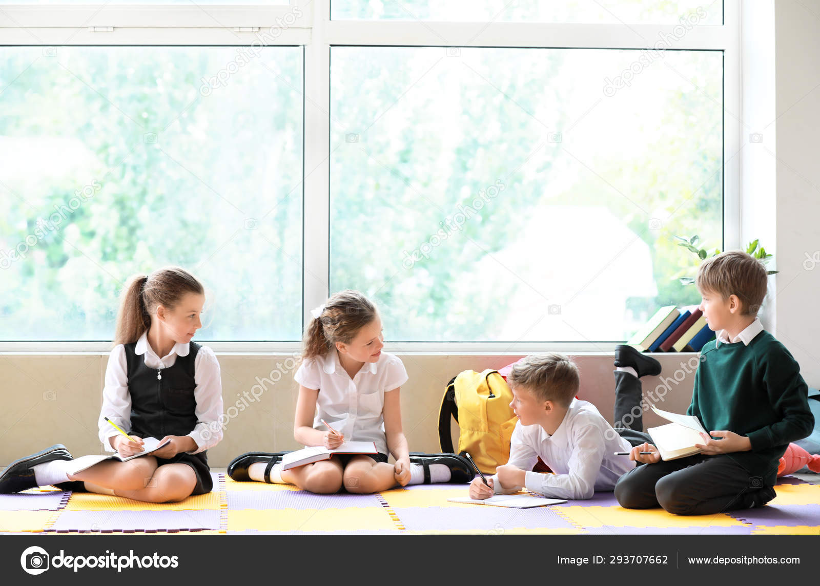 Cute little children doing lessons in classroom Stock Photo by ...