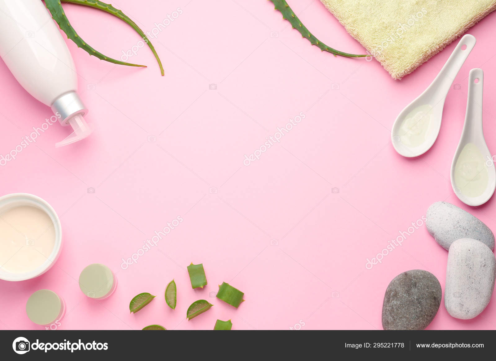 Cosmetic products with aloe leaves and spa stones on color background ...