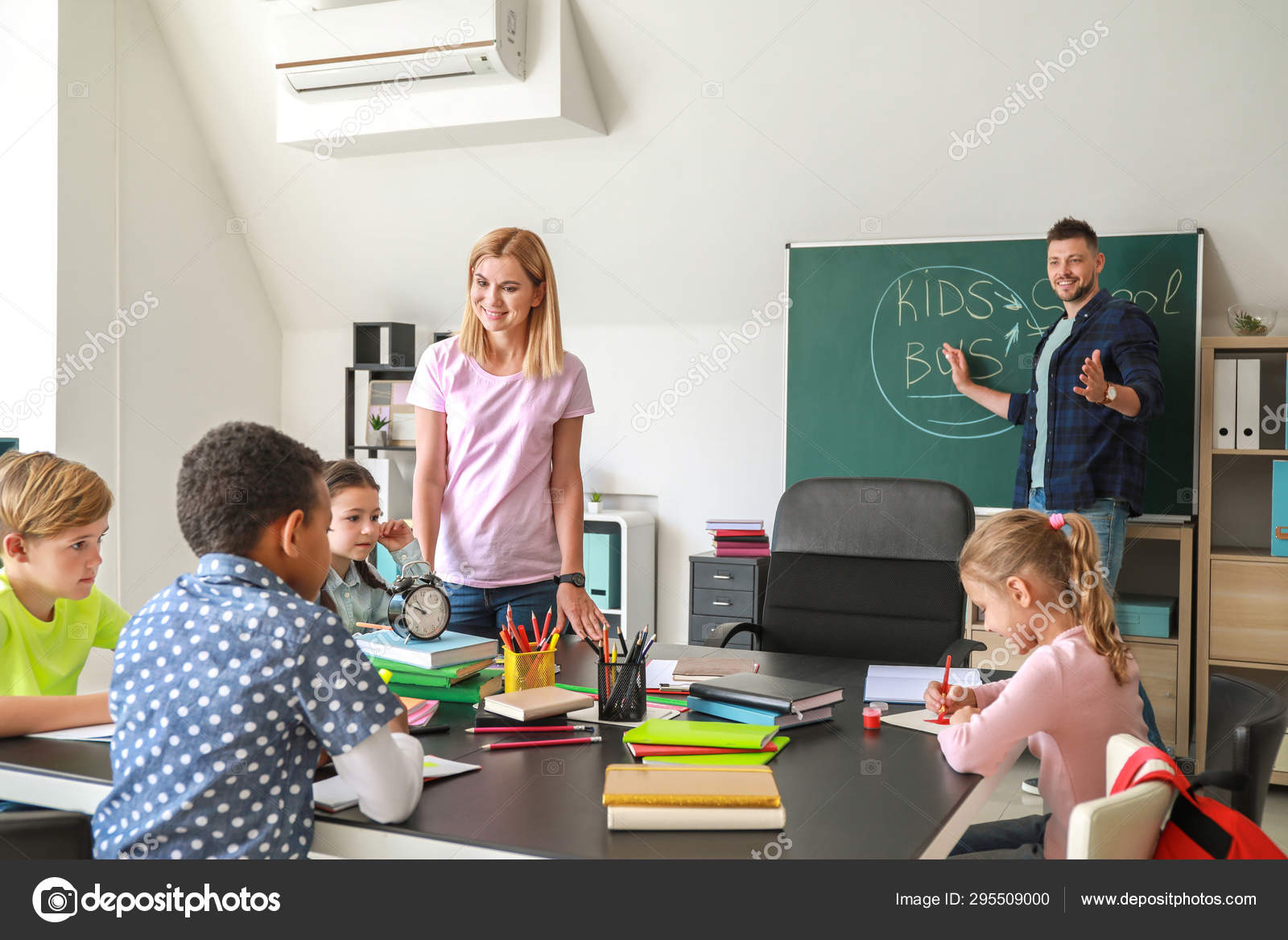 Teachers conducting lesson in classroom Stock Photo by ©serezniy 295509000