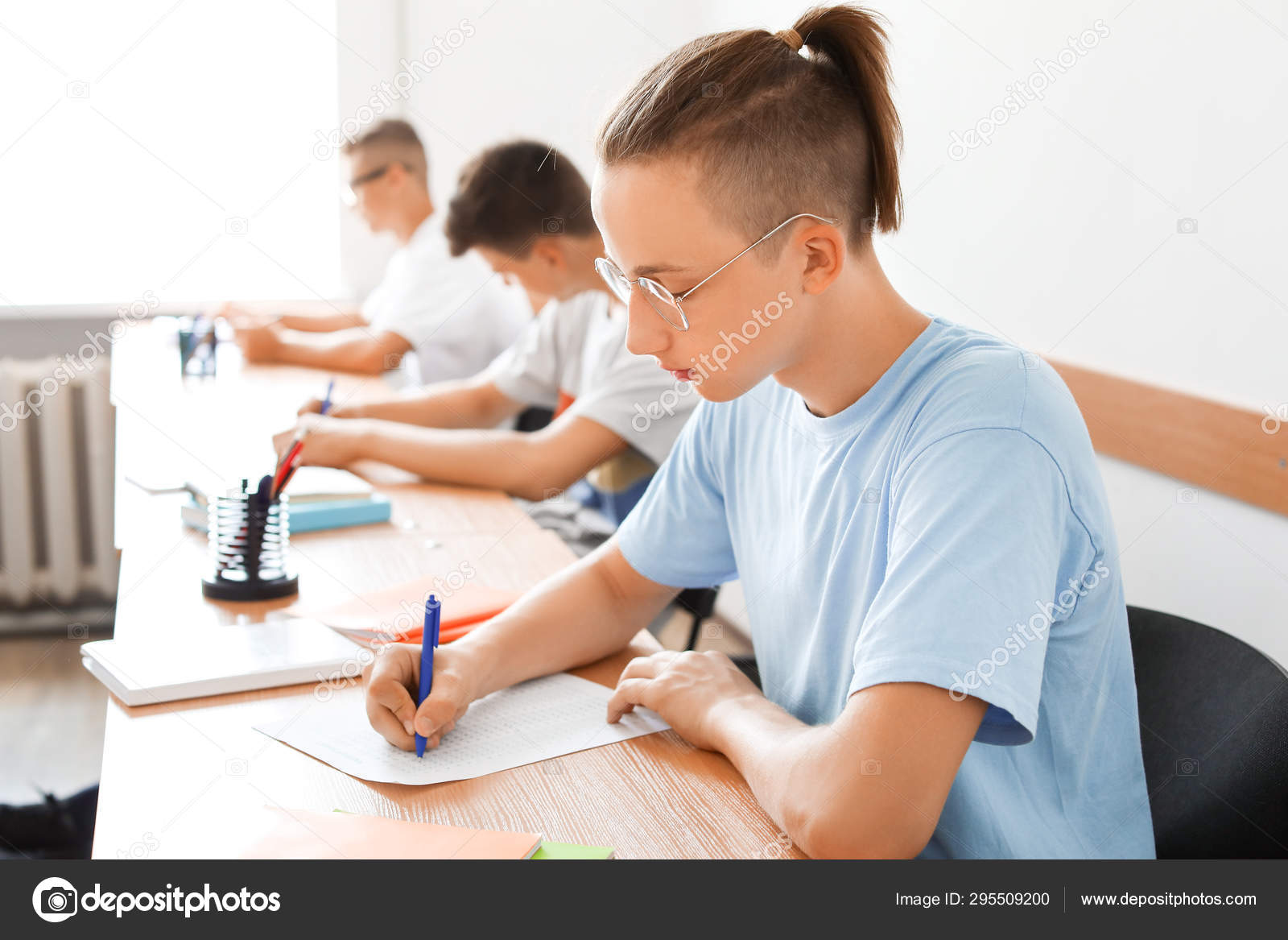 Pupils passing school test in classroom — Stock Photo © serezniy #295509200