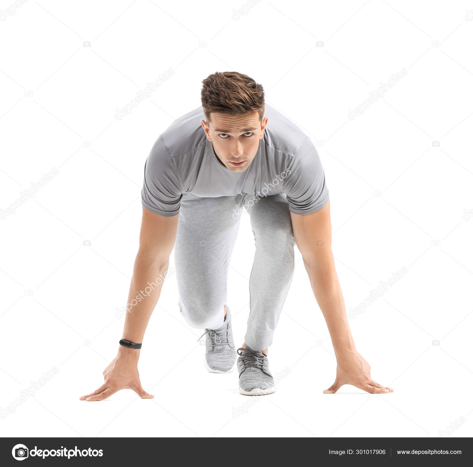 Sporty young man in crouch start position on white background Stock ...