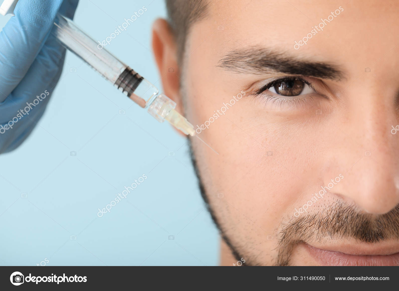 Handsome man receiving filler injection on color background, closeup ...