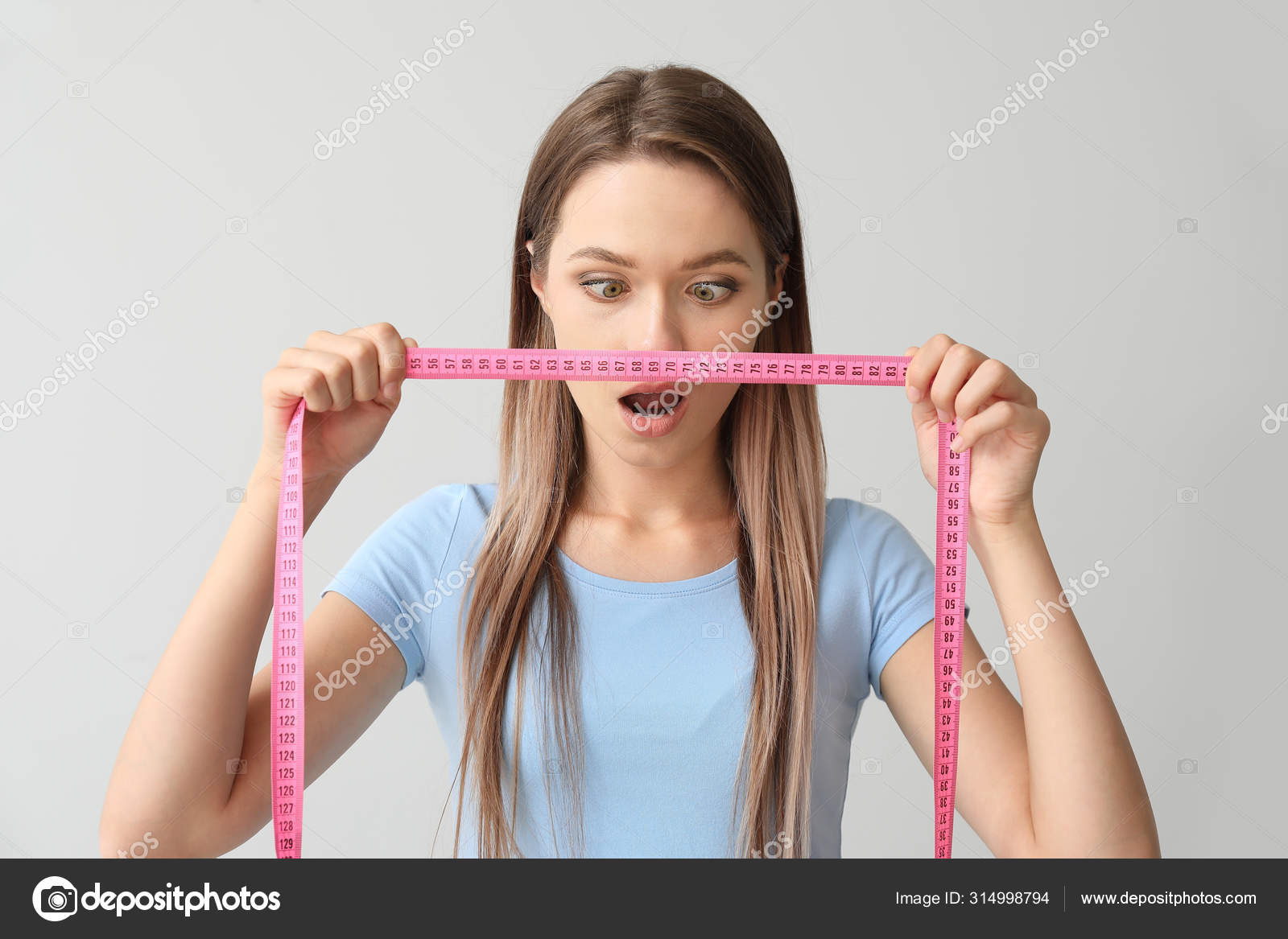 Shocked woman with measuring tape on light background. Diet concept ...