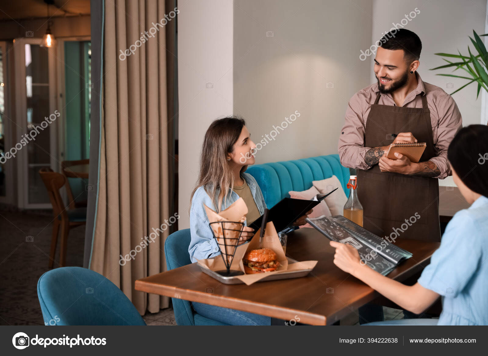 Waiter Serving Clients Restaurant Stock Photo by ©serezniy 394222638