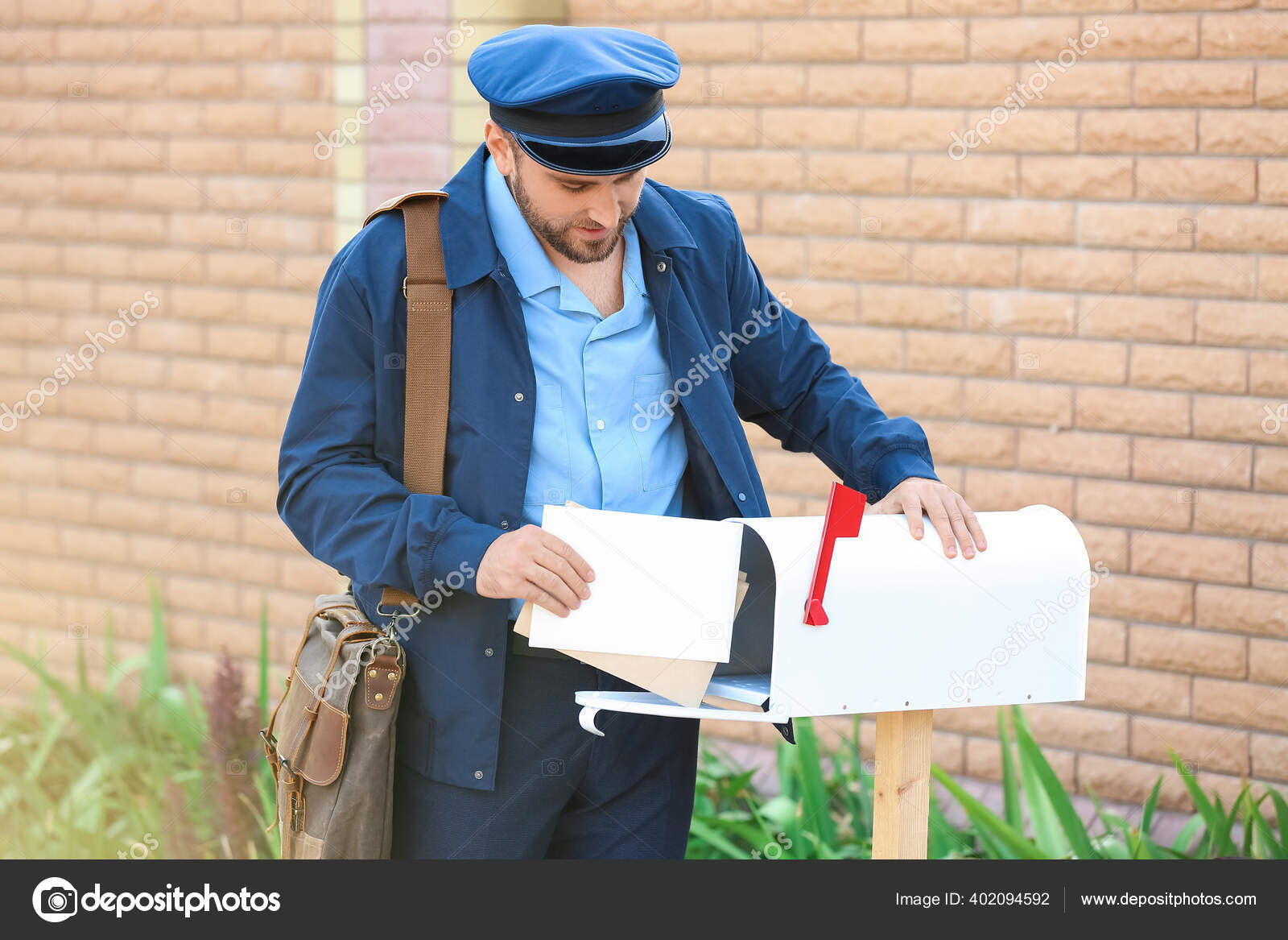 Handsome Young Postman Putting Letters Mail Box Outdoors Stock Photo by ...