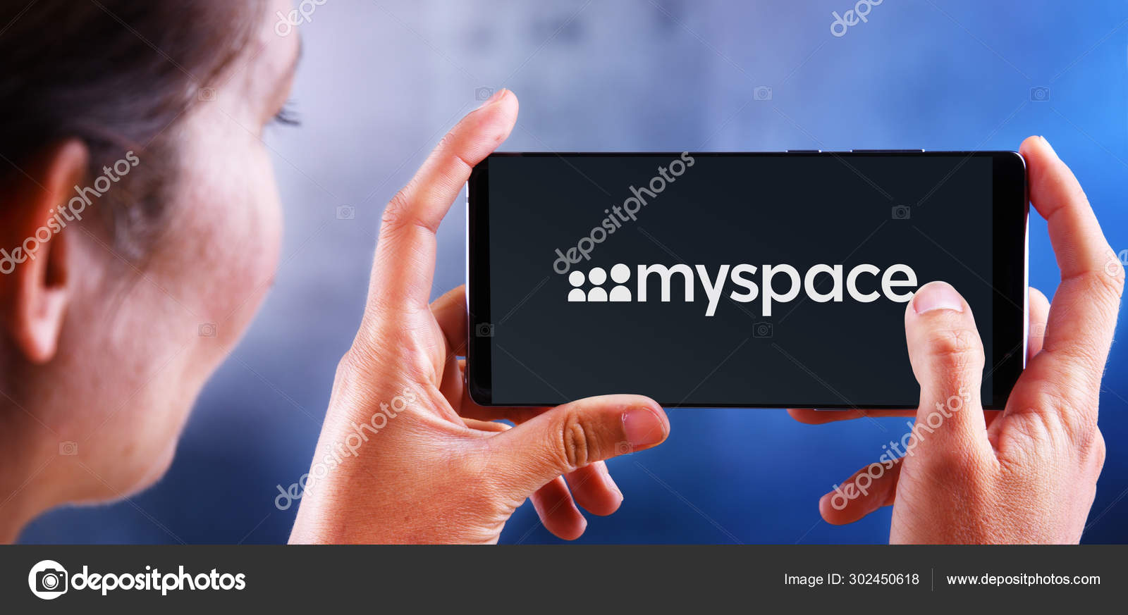 Woman holding smartphone displaying logo of Myspace — Stock Editorial ...