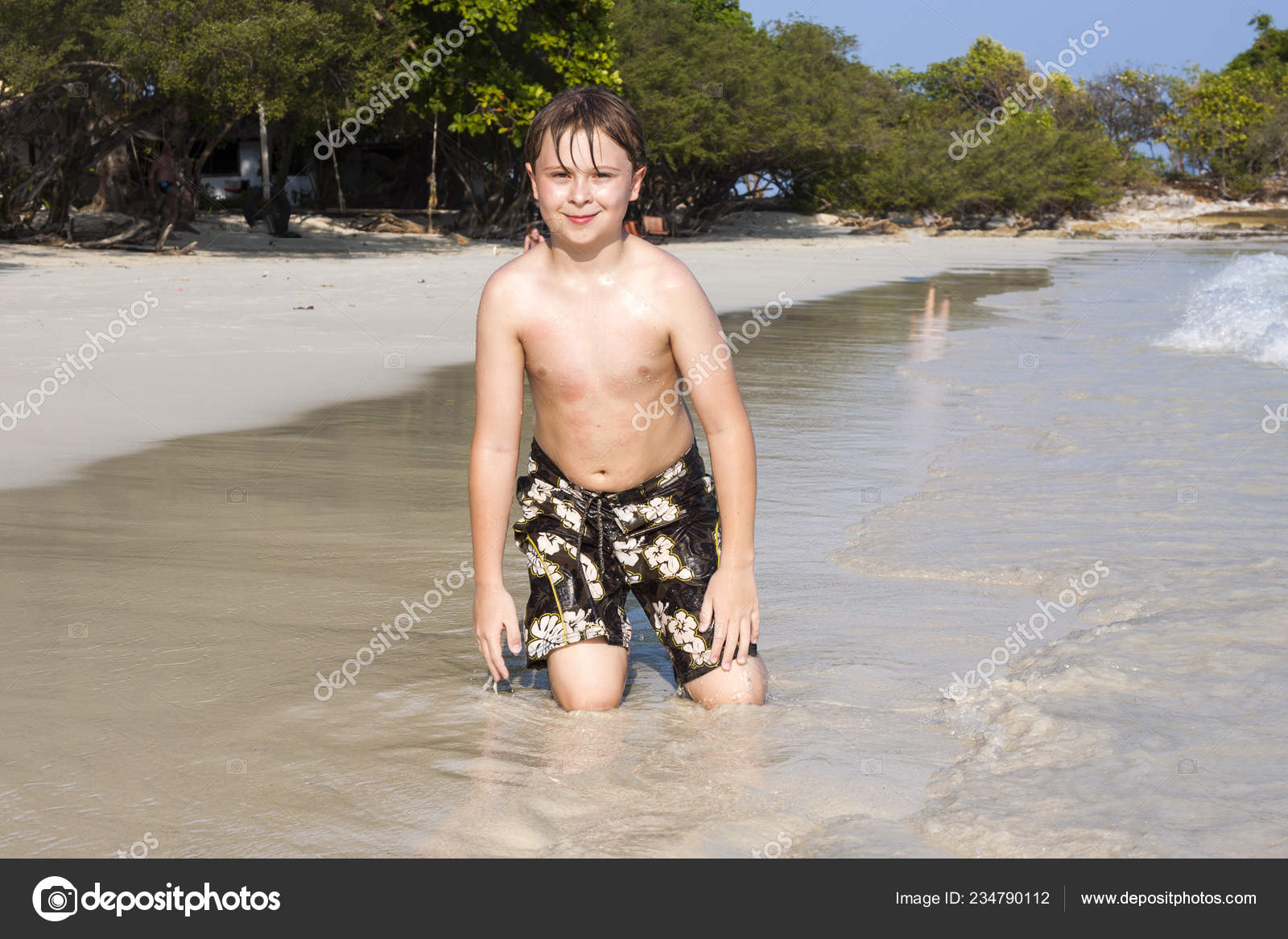 Young Boy Enjoys Sitting Beach Spume — Stock Photo © Hackman #234790112