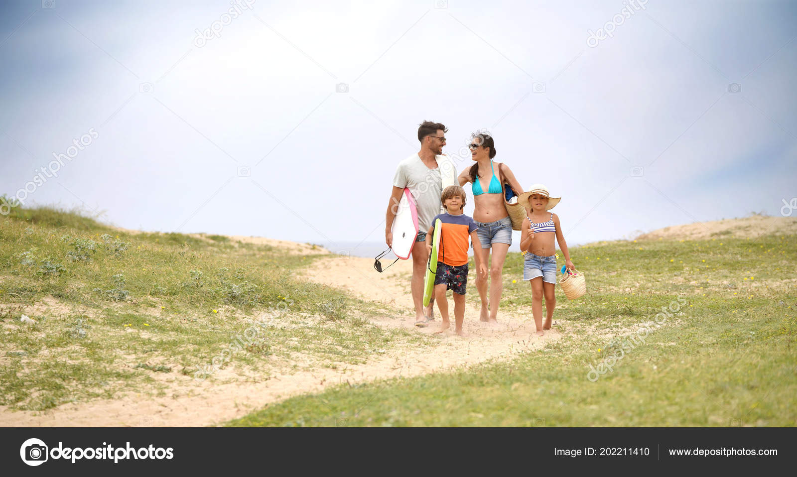 Family Walking Beach Sand Dune Path Stock Photo by ©Goodluz 202211410