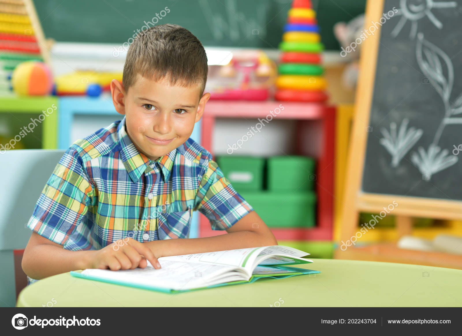 Young Boy Reading Book Classroom Stock Photo by ©aletia 202243704