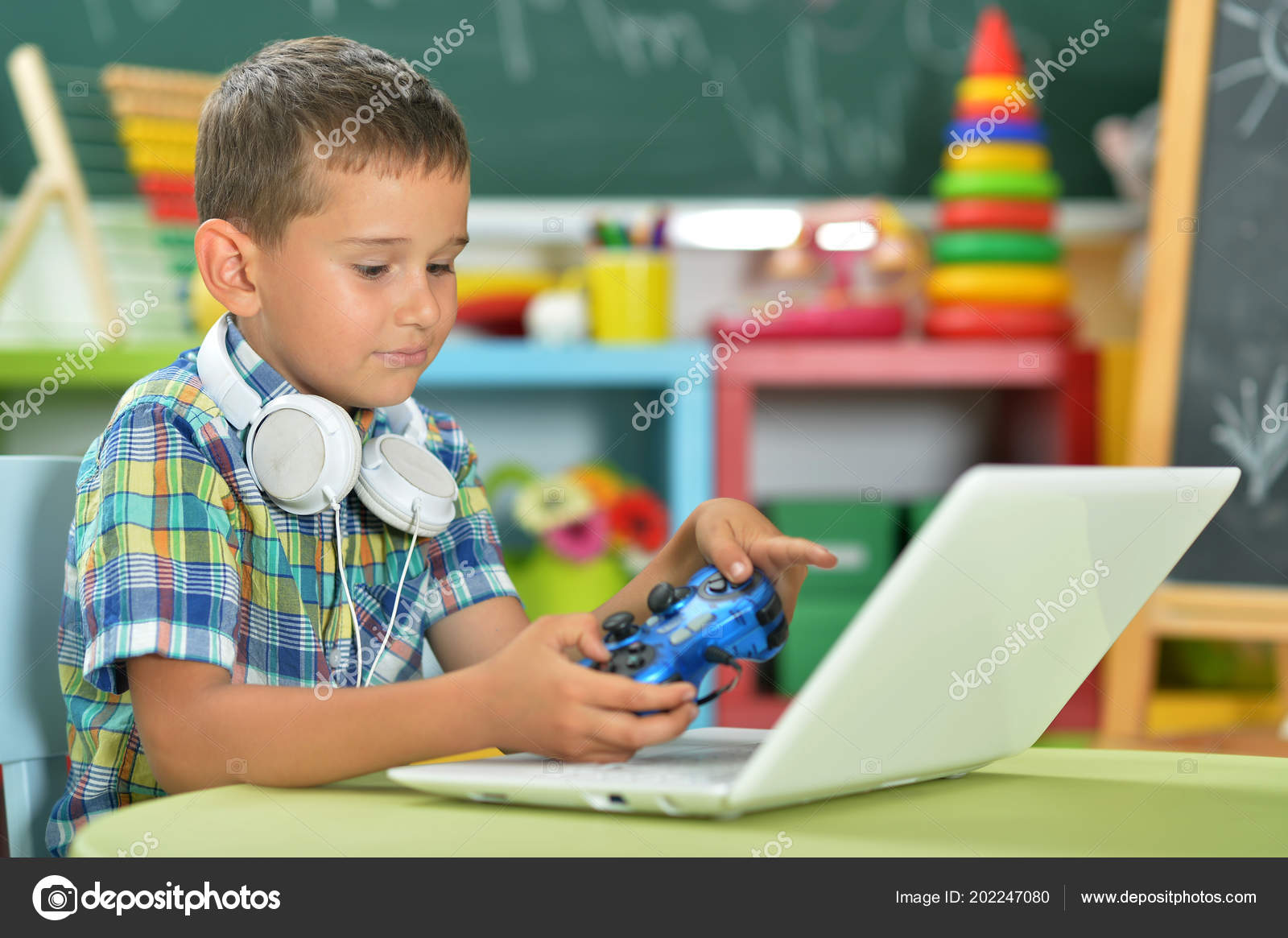 Little boy using laptop Stock Photo by ©aletia 202247080