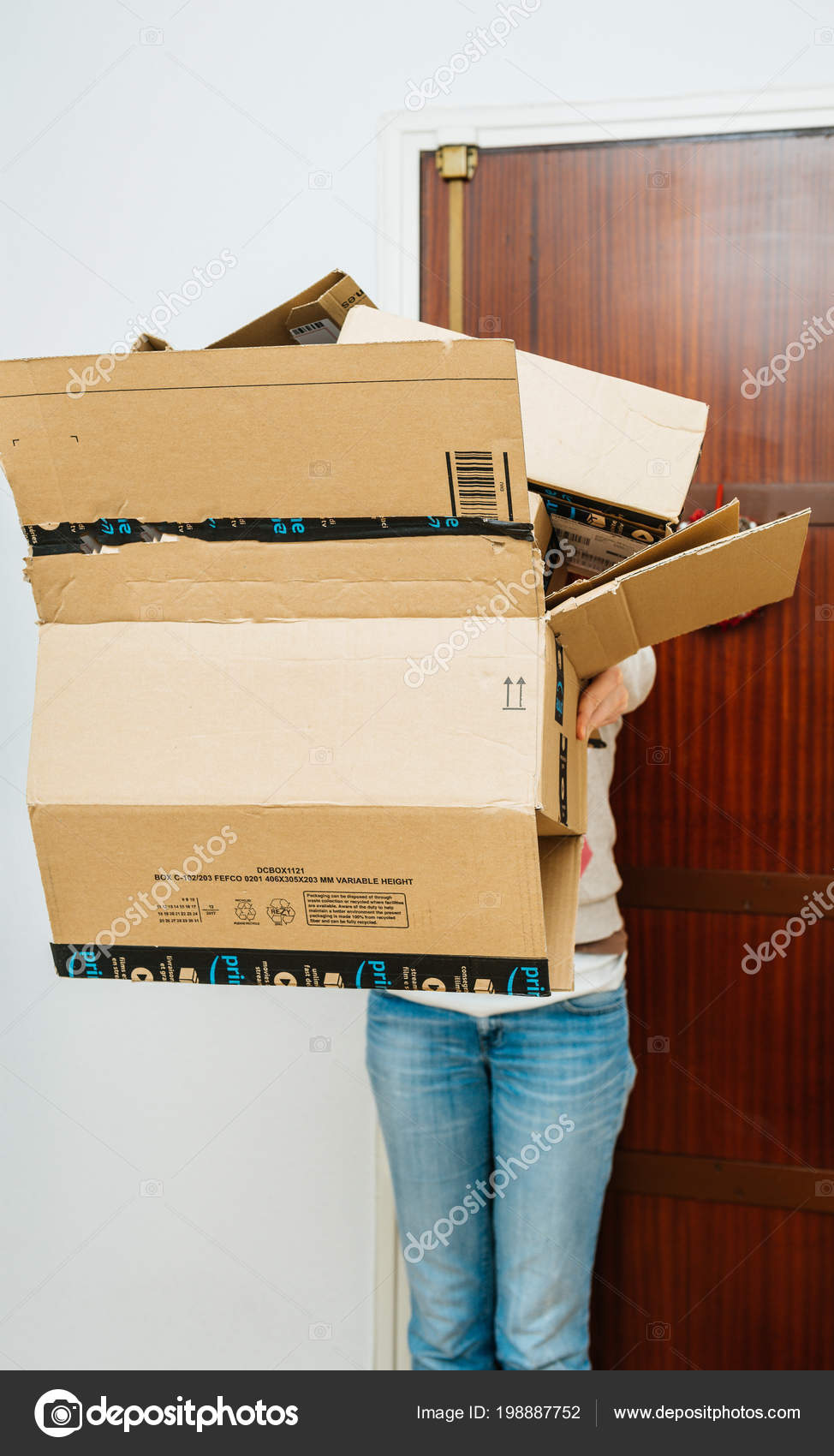 Woman holding stack of Amazon Prime packages — Stock Editorial Photo ...