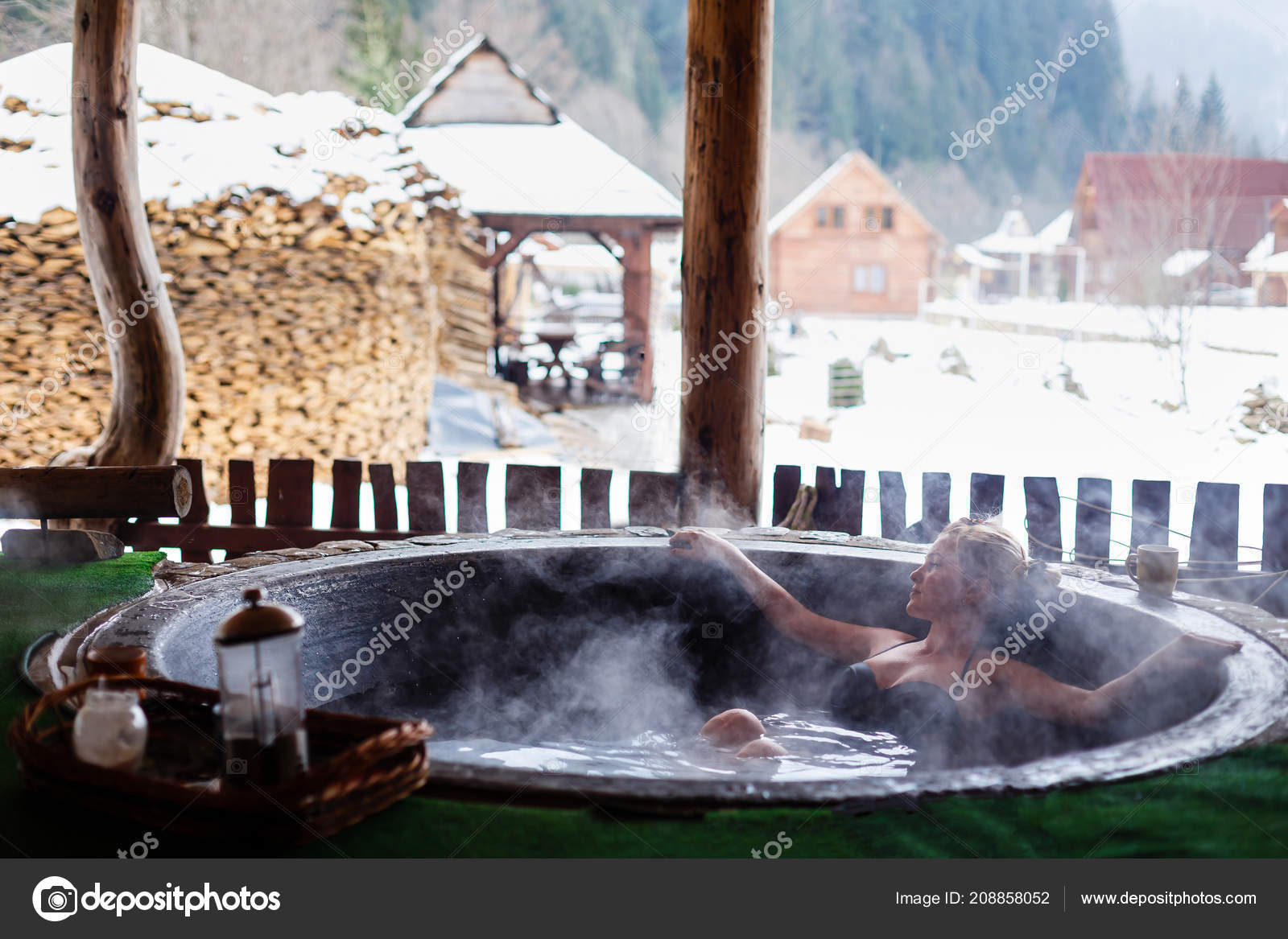 Young Woman Open Air Bath While Snowing Stock Photo by ©sinenkiy 208858052