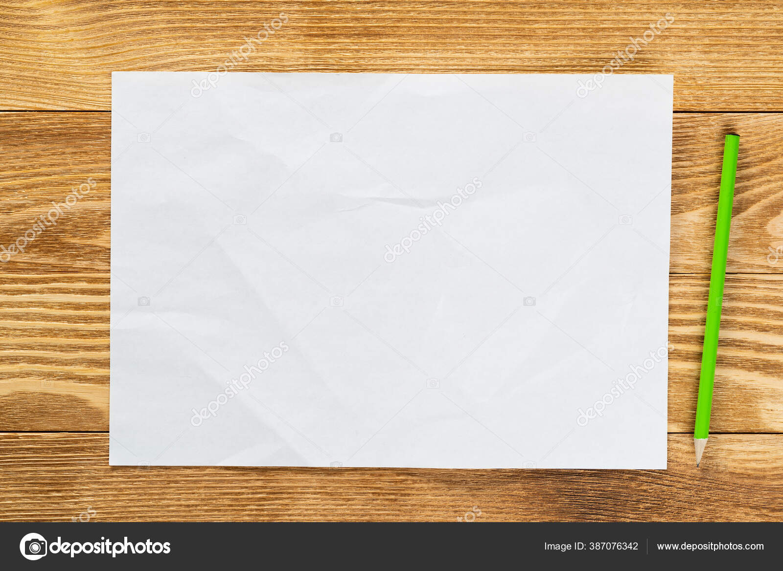 Sheet of paper lying on wooden table Stock Photo by ©Khakimullin 387076342