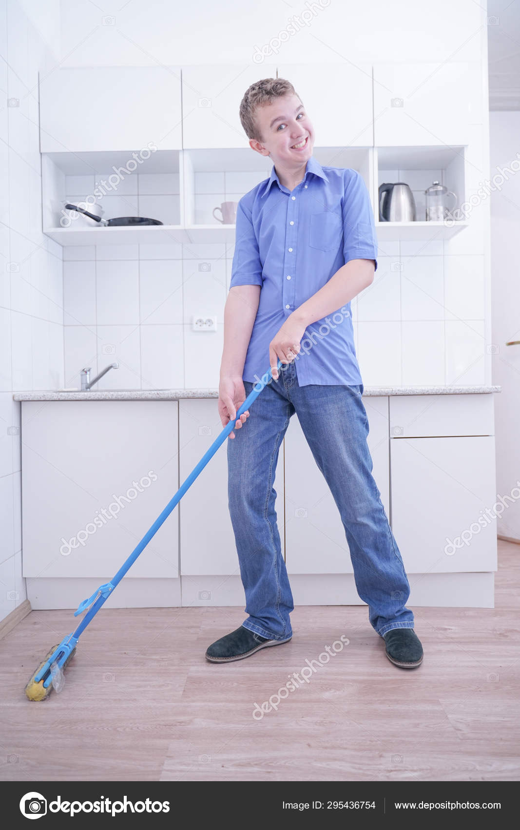 Teenager Boy Mopping The Floor and helps his parents to clean on ...