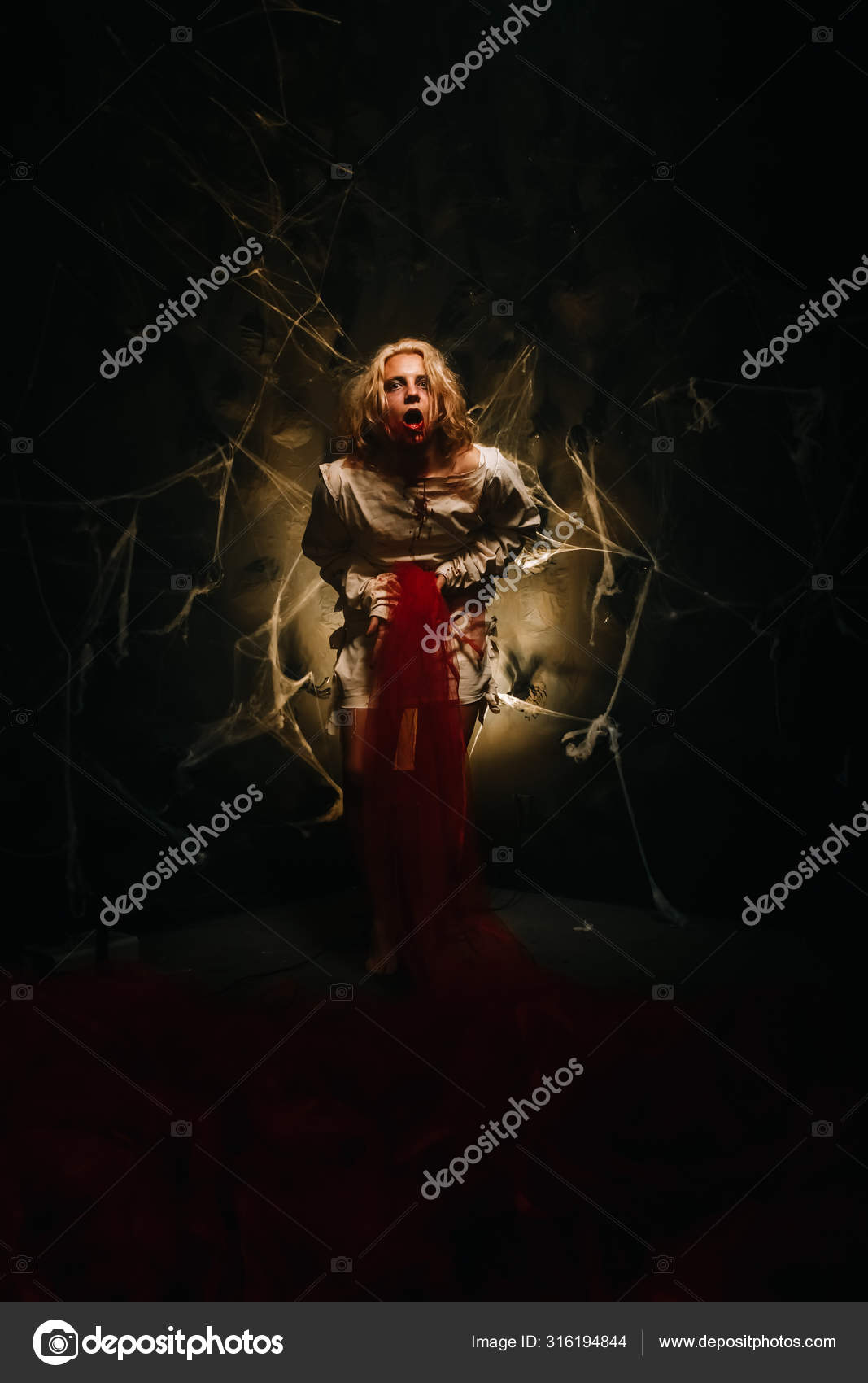 A psycho in a straitjacket vomits on a black background in the Studio ...