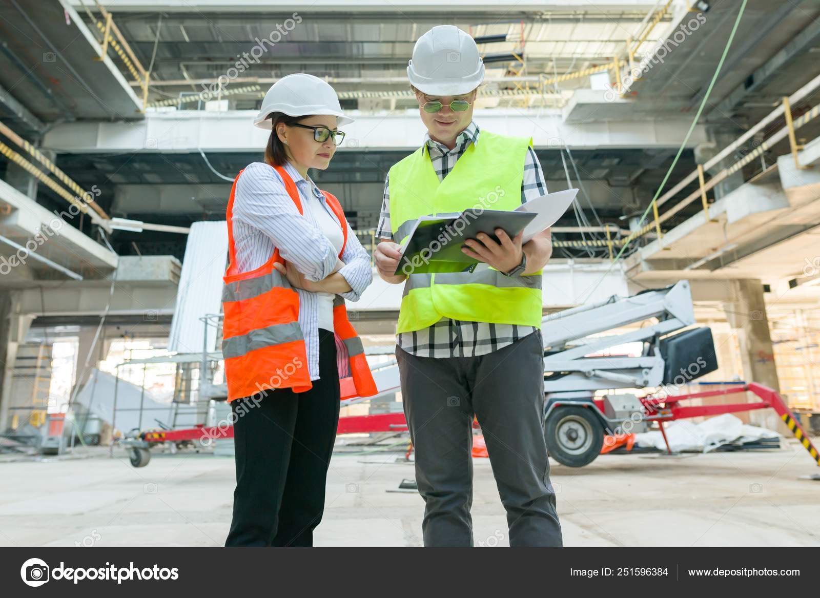 Group of engineers, builders, architects on the building site ...