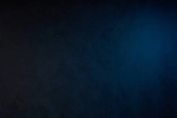 Blue grey abstract background, the Studio wall is illuminated by ...