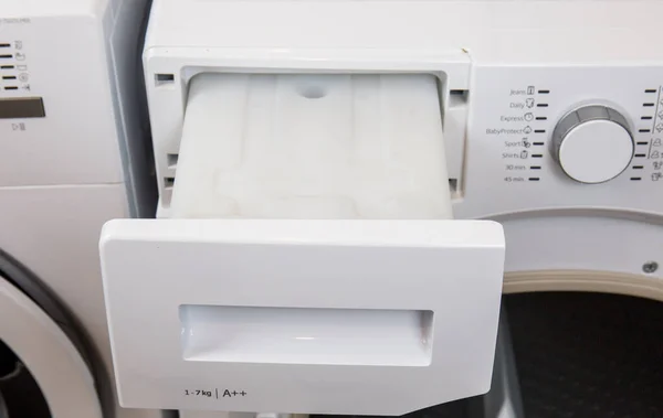 clothes dryer water tank, man maintains the machine regularly, empties ...