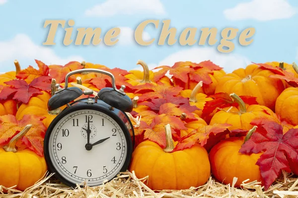 Time change message with a retro alarm clock with pumpkins and f ...
