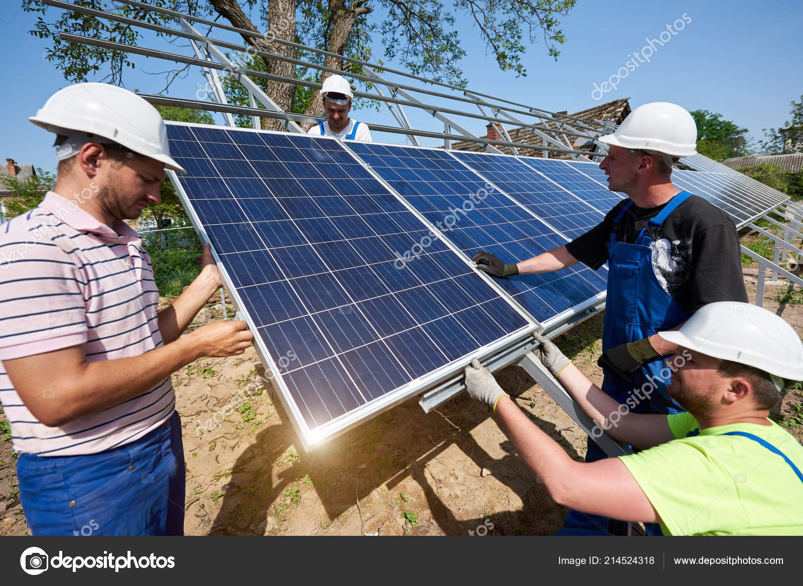 Team Four Technicians Working Exterior Voltaic Solar Panel System ...