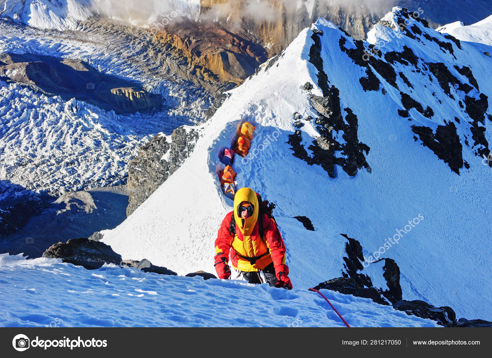 Climber reaches the summit of mountain peak. Success, freedom and ...