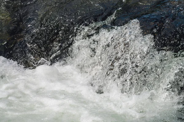 Natural texture of foamed water surface. Rapids of river close-up. Fast ...