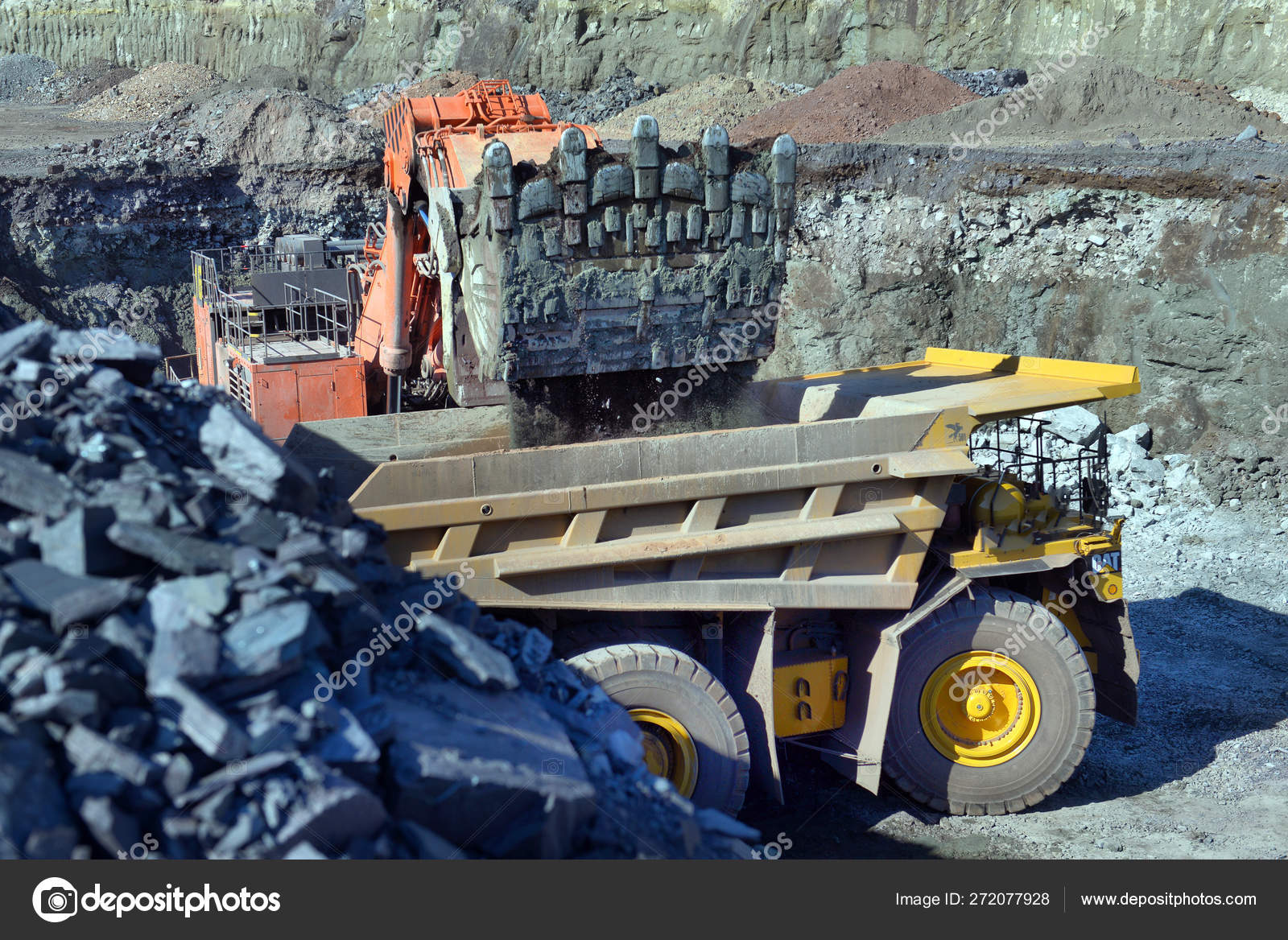 Large quarry dump truck. Loading the rock in the dumper. Loading ...