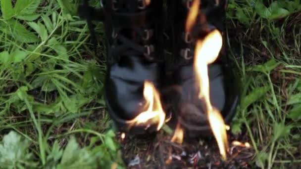 Old leather black high punk womens boots burn with fire standing on the ...