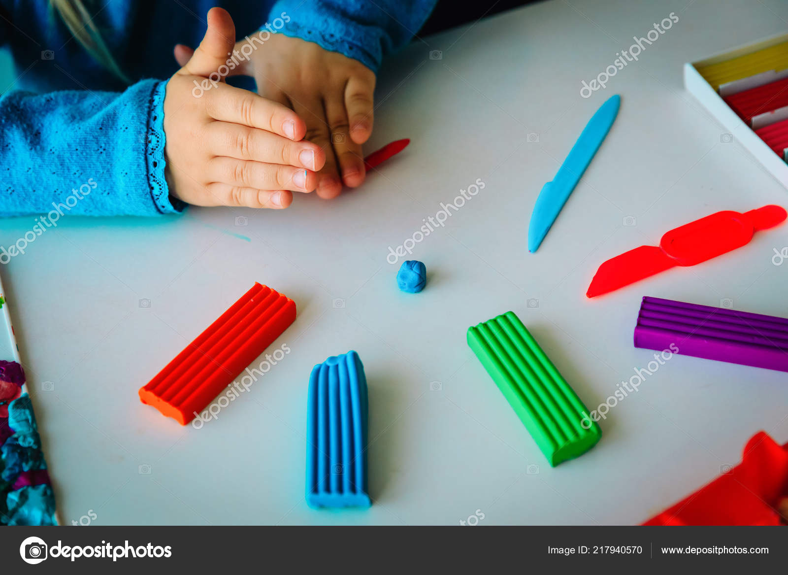 Child playing with clay molding shapes, learning Stock Photo by ...