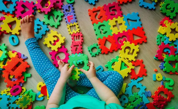 Little girl learning numbers and shapes, play with puzzle Stock Photo ...