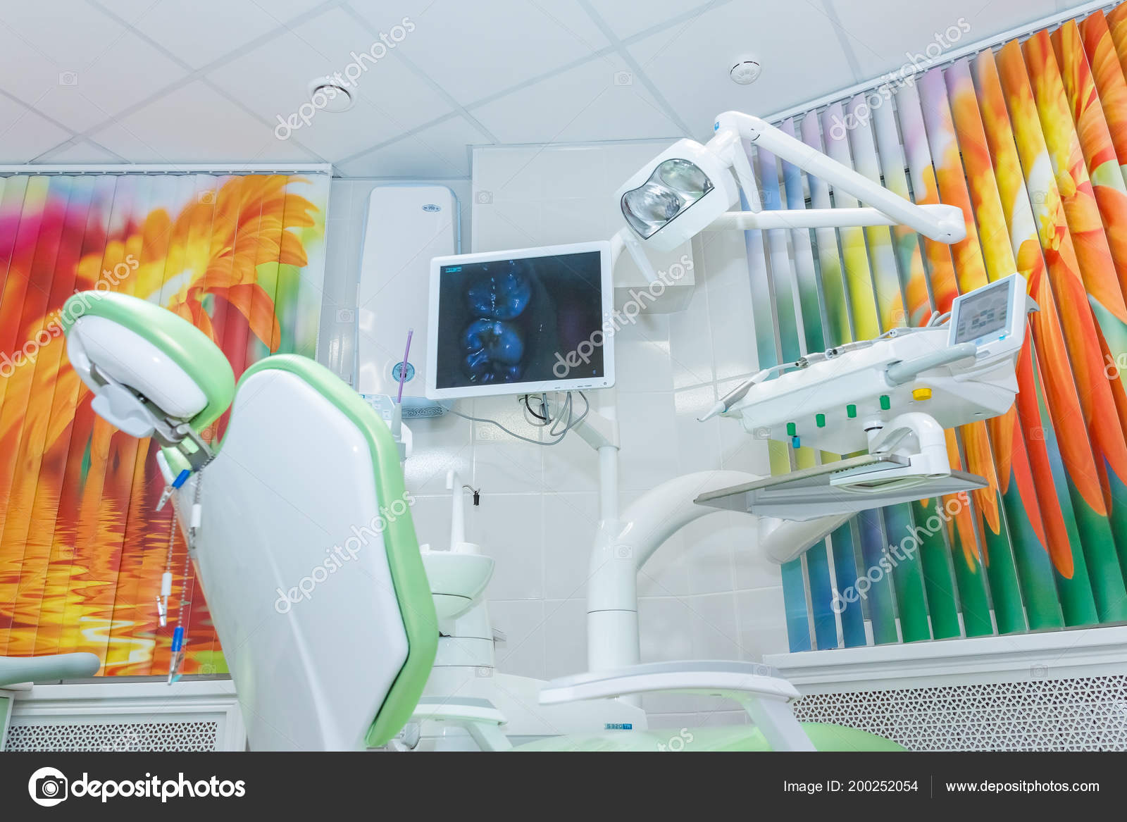 Modern dental office with green chair and professional computer ...