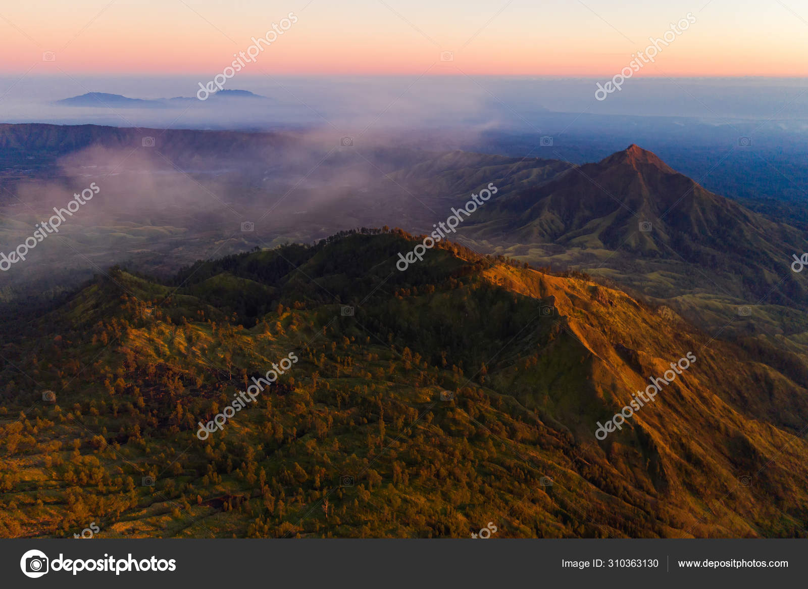 Aerial view of rock cliff at Kawah Ijen volcano with turquoise s ...