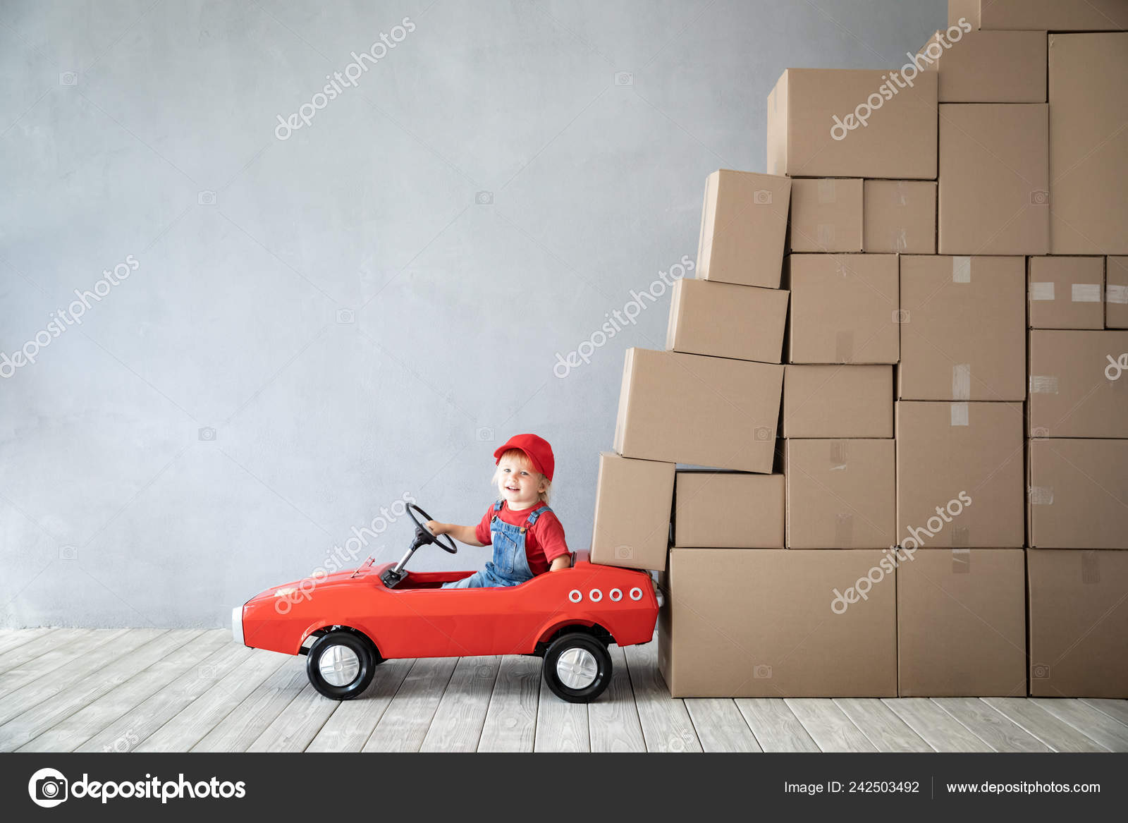 Happy Child Playing New Home Kid Driving Toy Car Moving Stock Photo by ...
