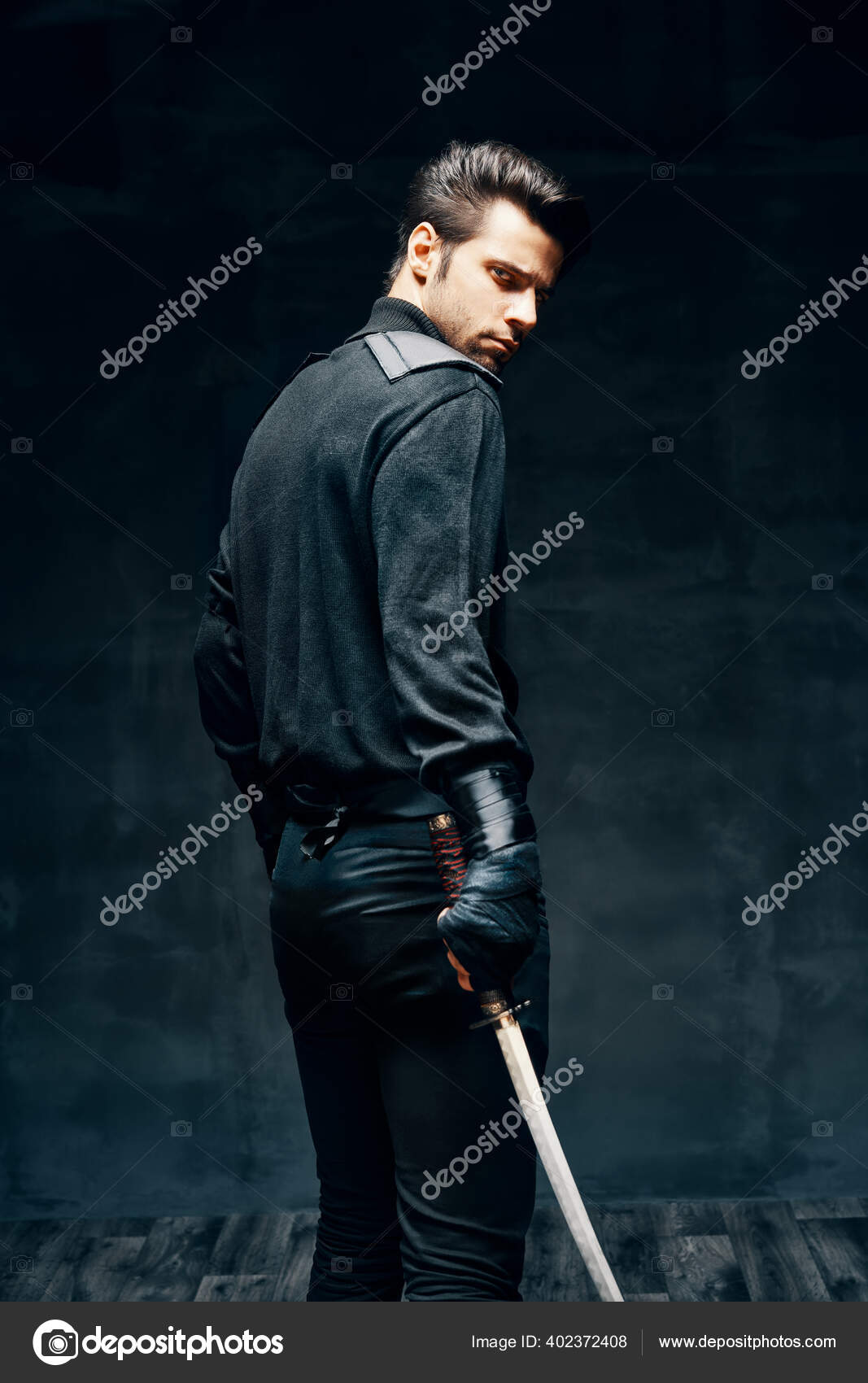 Warrior man posing with a sword — Stock Photo © Gladkov #402372408