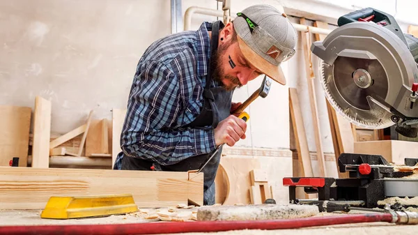 Close up experienced carpenter in work clothes and small buiness owner ...