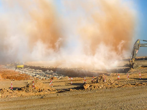 Dust clouds after the detonator blasting on the construction site ...