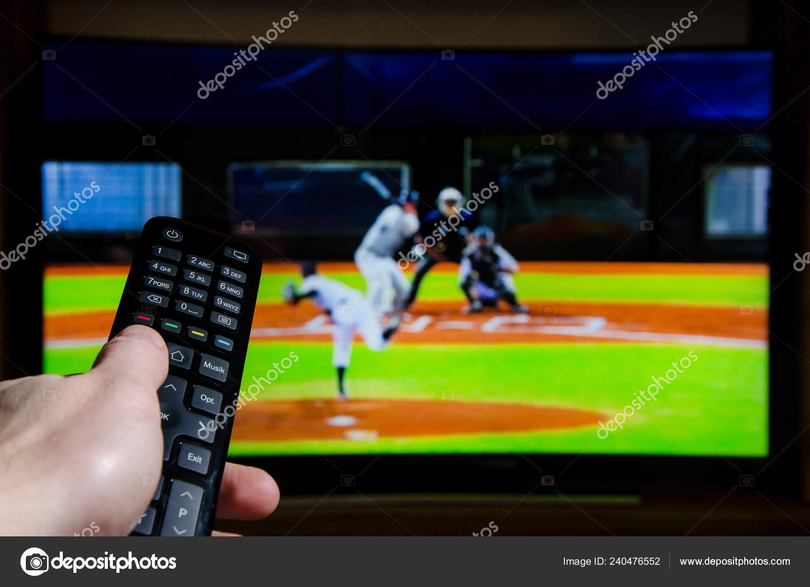 Man Watching Baseball Using Remote Controller — Stock Photo © Oleksandr ...