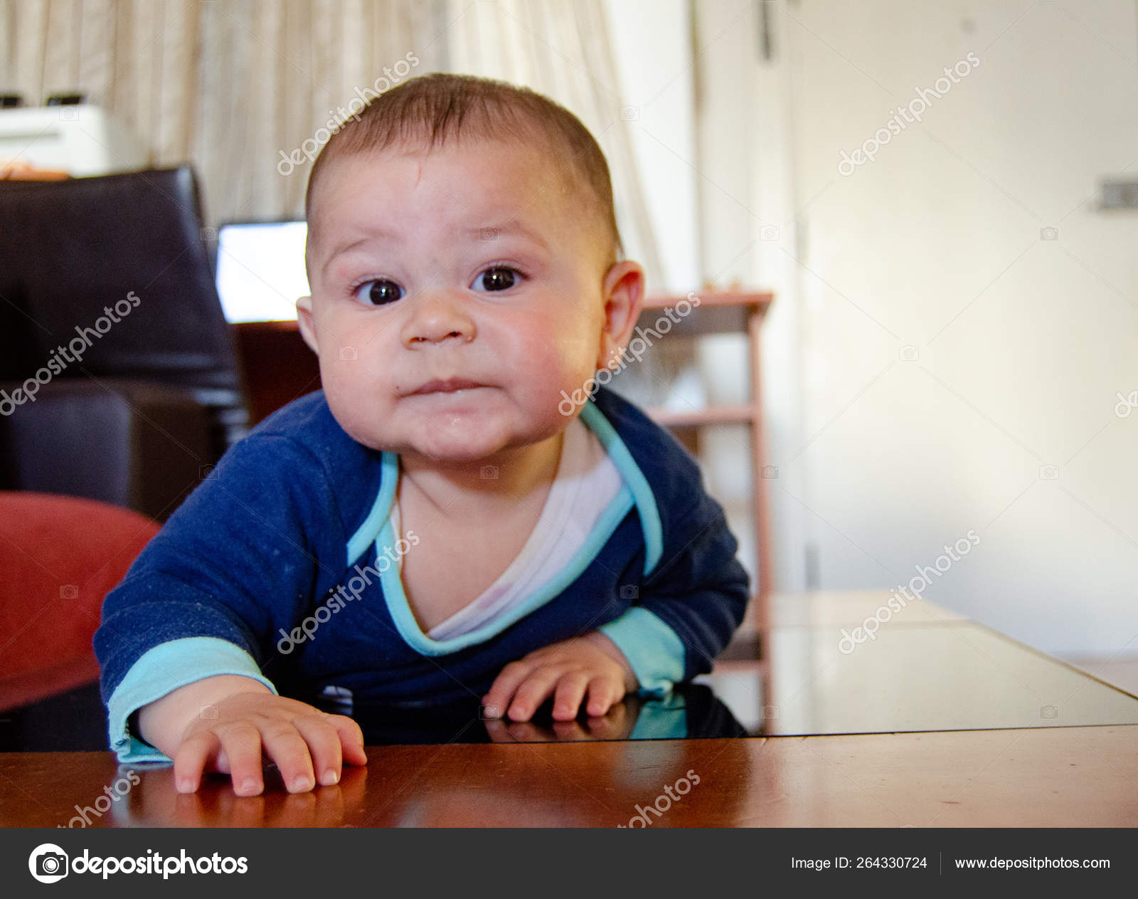 Cute six months old baby boy drooling on the flor and making funny ...